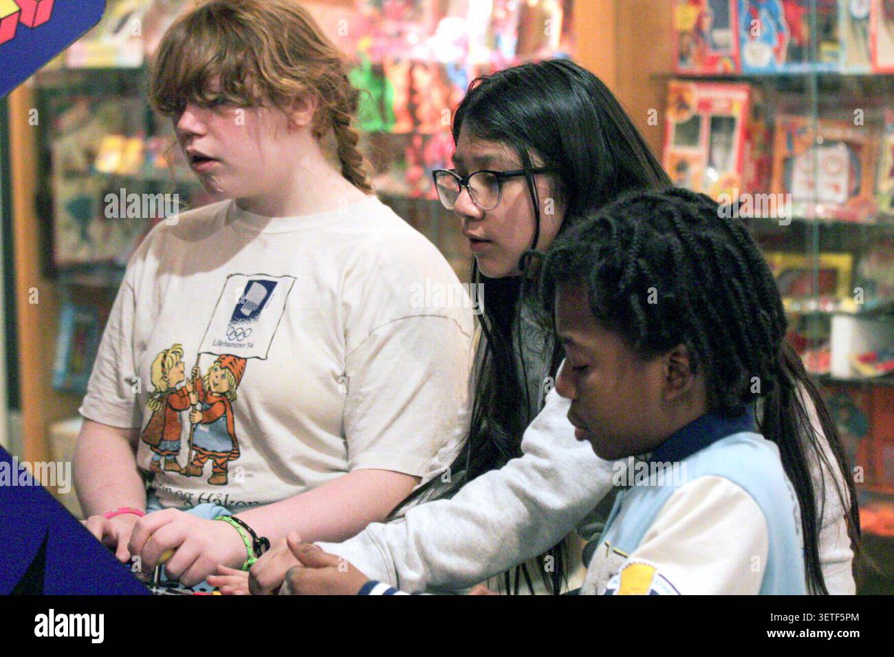 Three Lake Hills Elementary School students play an arcade game at ...