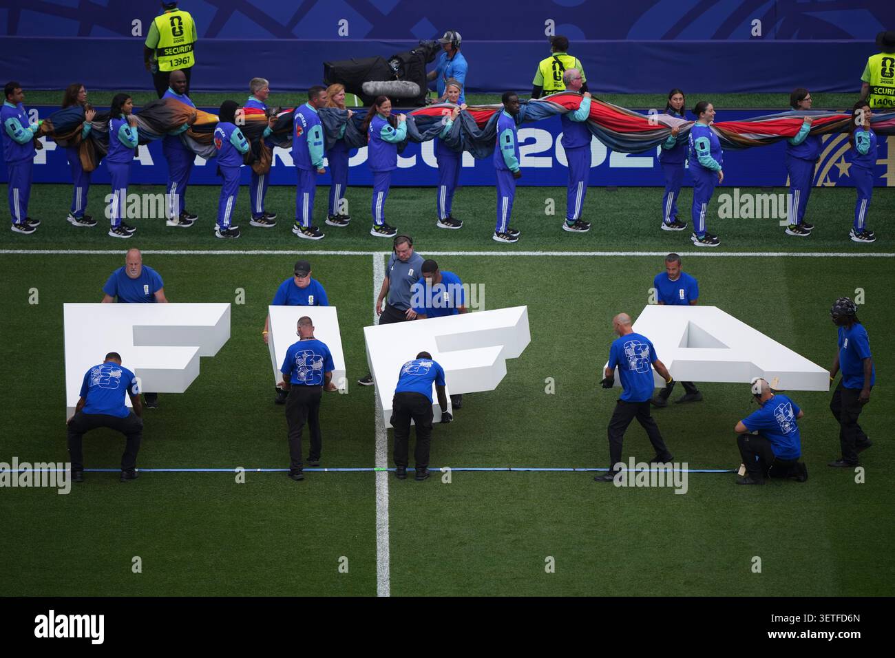 Volunteers carry a FIFA sign prior to the World Cup Group I soccer ...