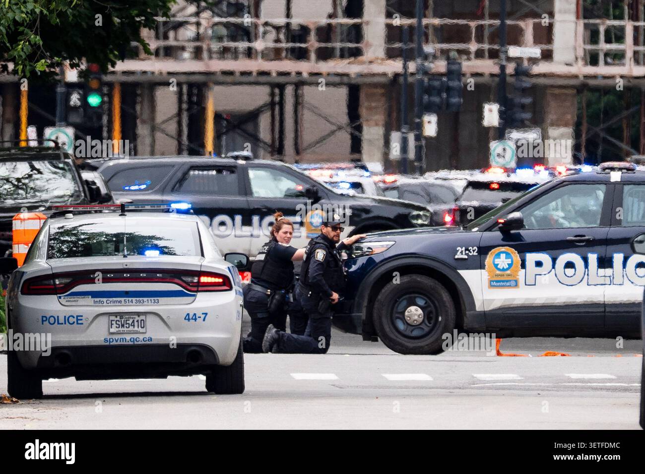 Montreal police work the scene of a shooting in Montreal on Monday ...