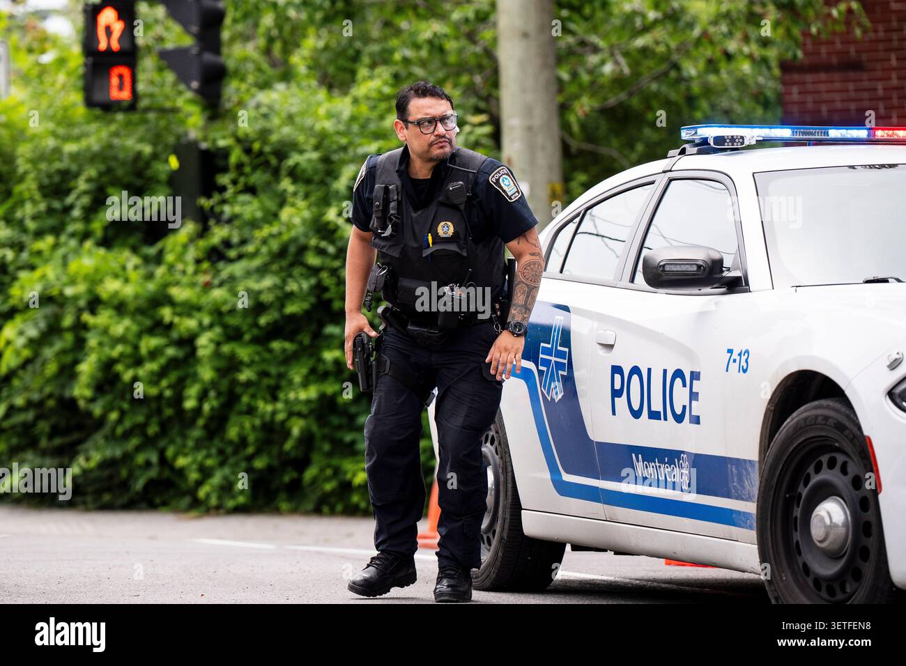 Montreal police work the scene of a shooting in Montreal on Monday ...