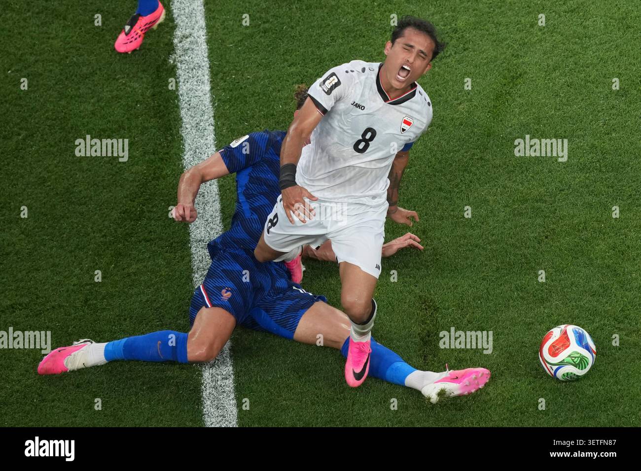 Iraq's Ibrahim Bayesh (8) falls as he is tackled by France's Adrien ...