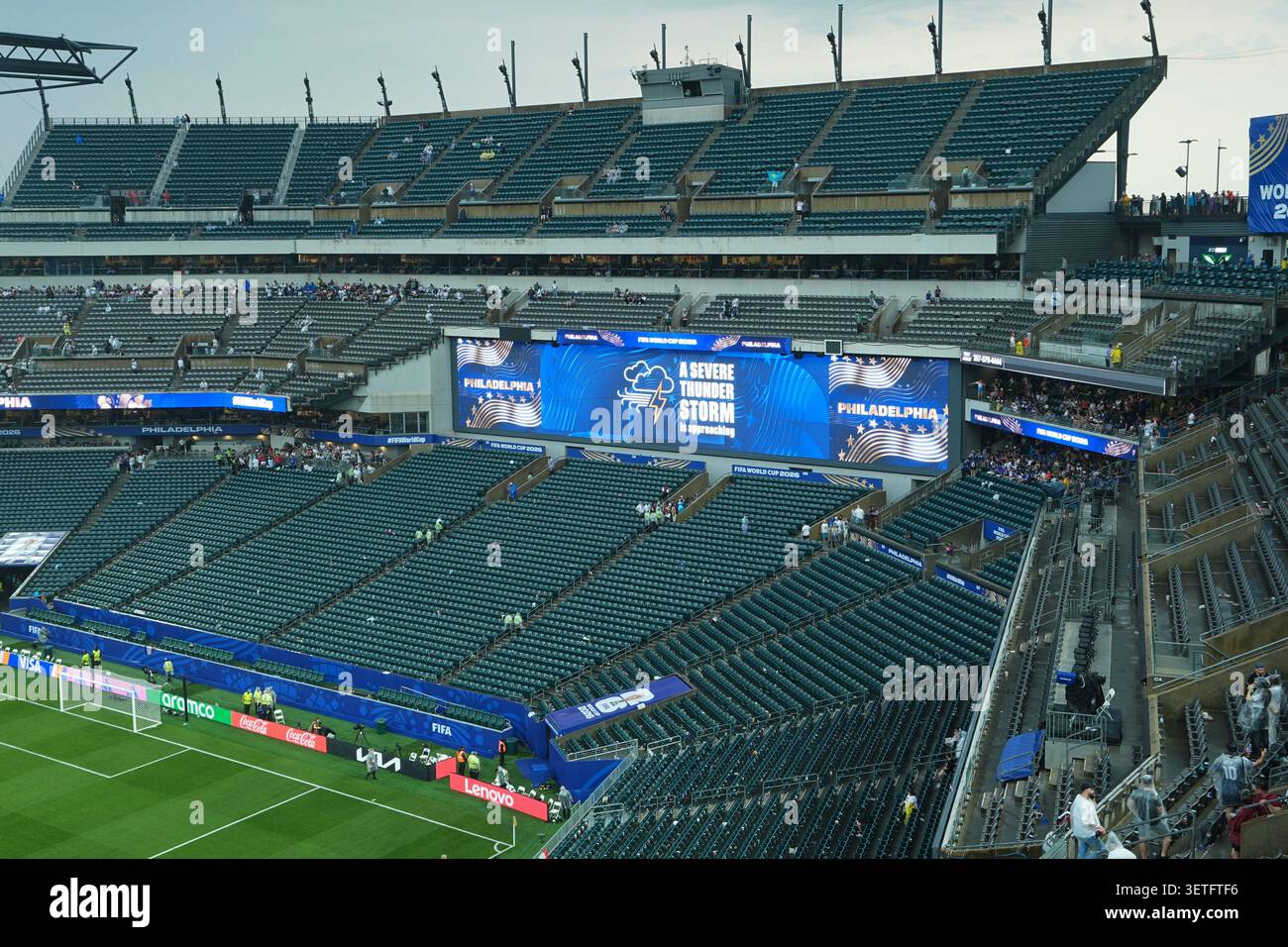 A sign is shown advising fans to exit seating as a severe weather storm ...