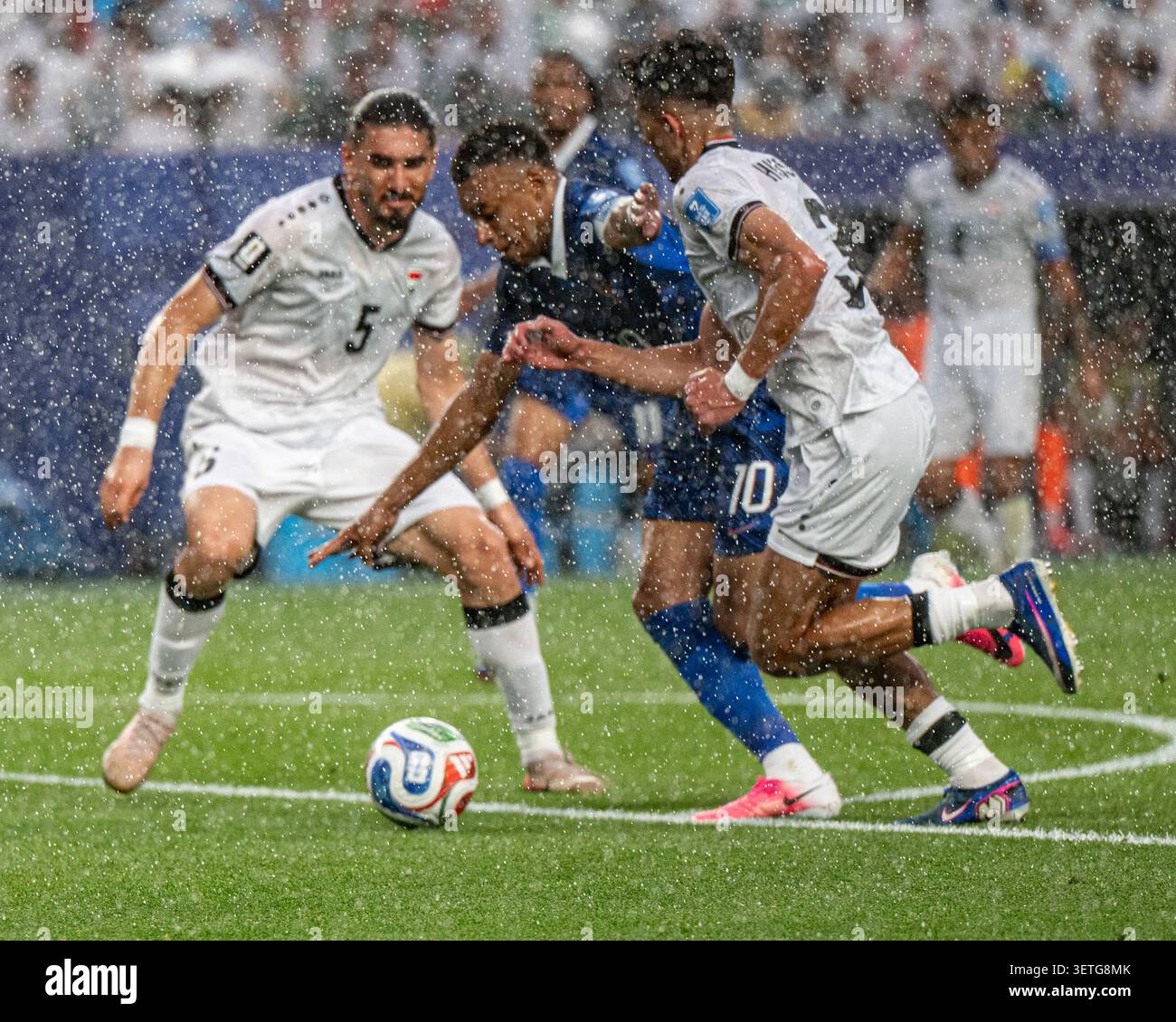 Kylian Mpappe of France dribbles in the rain during the France vs. Iraq ...