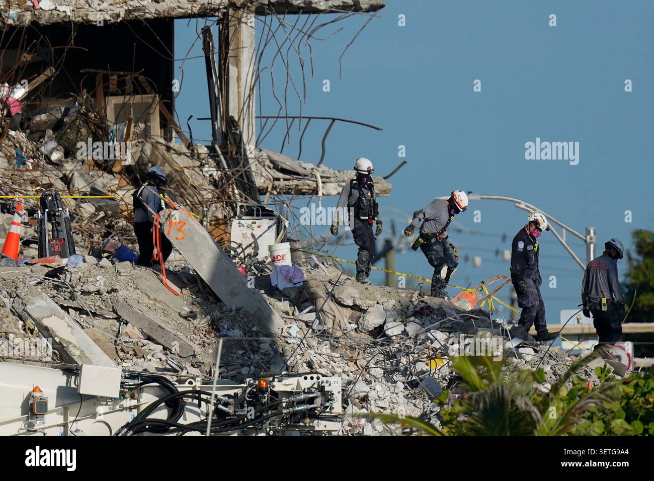 FILE - Search and rescue workers descend from the rubble pile at the ...