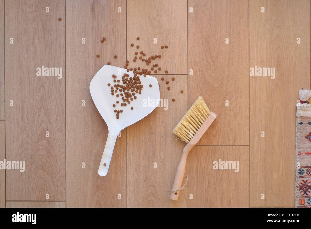 Food scattered on the floor with a dustpan and brush nearby Stock Photo ...
