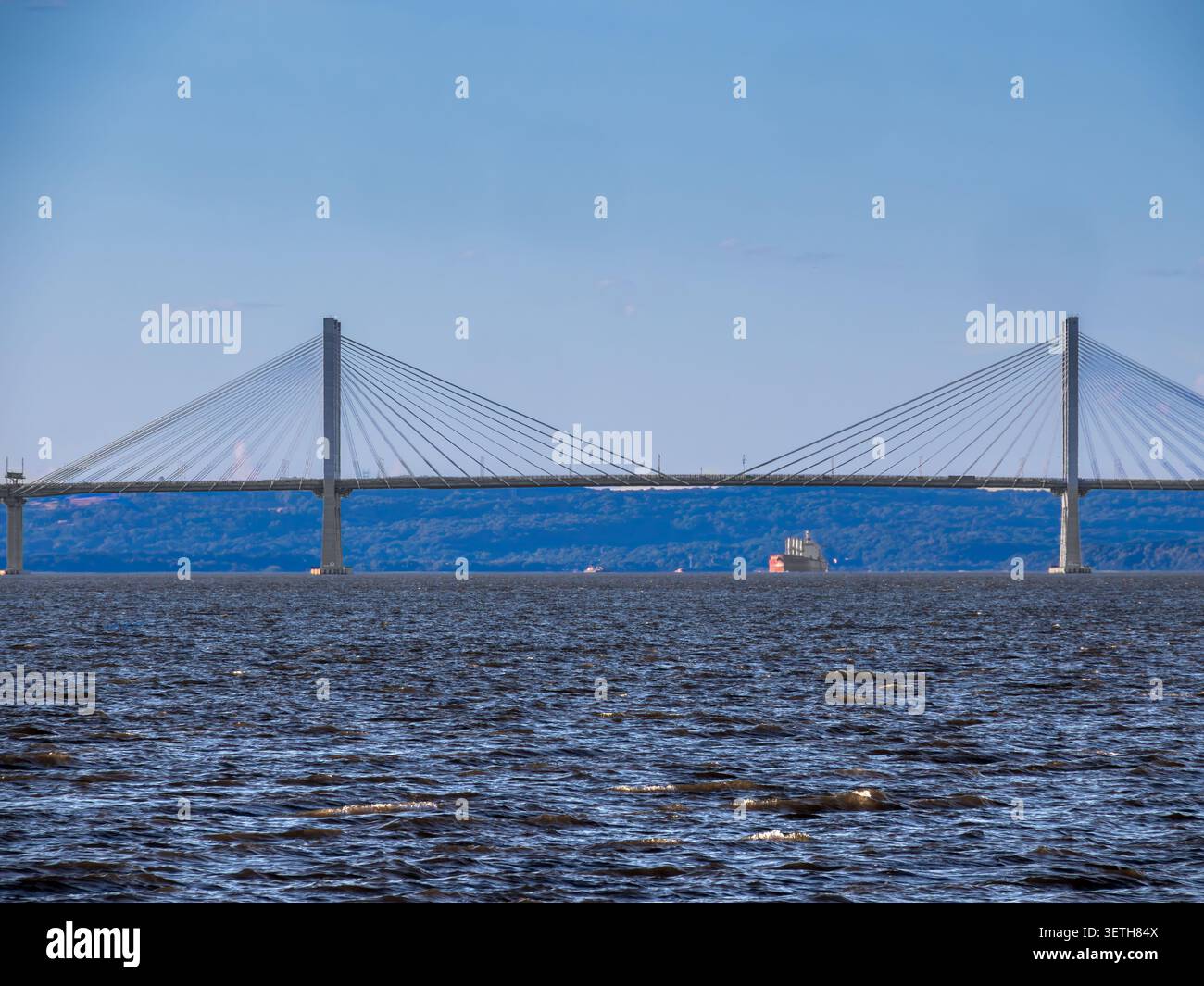 Viewed from Dobbs Ferry, NY, a container ship prepares to pass under ...