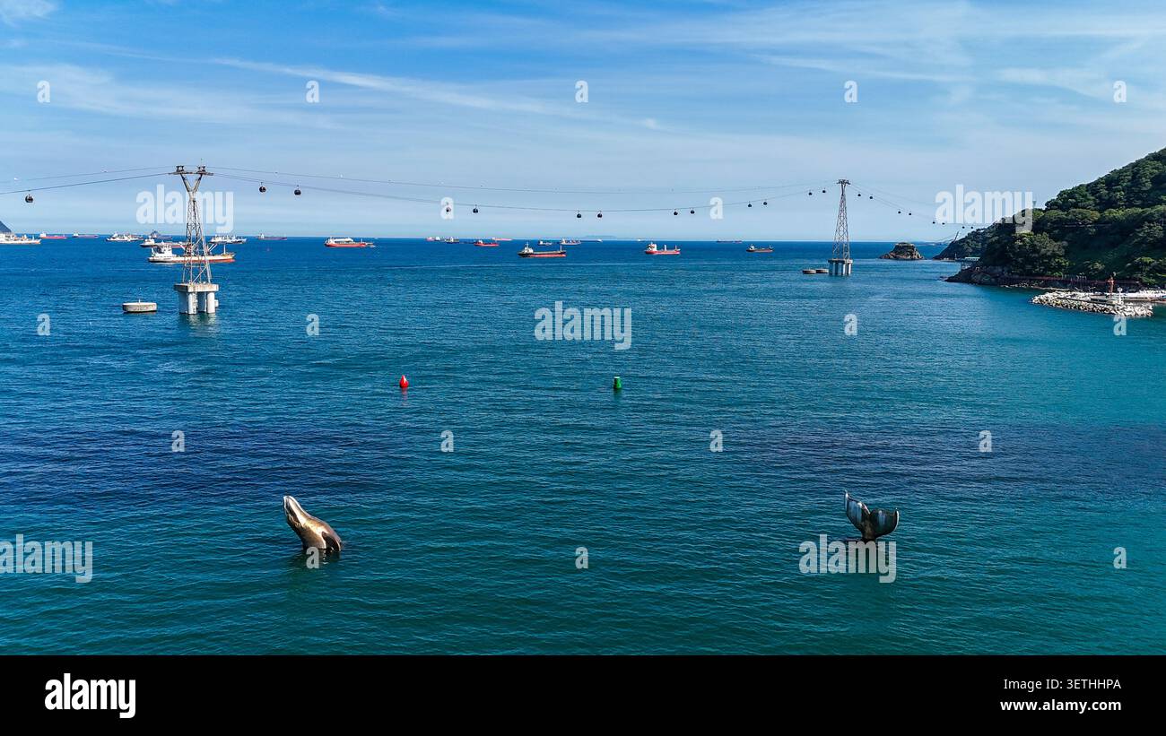 Songdo marine cable car transports passengers over the bay, with cargo ...