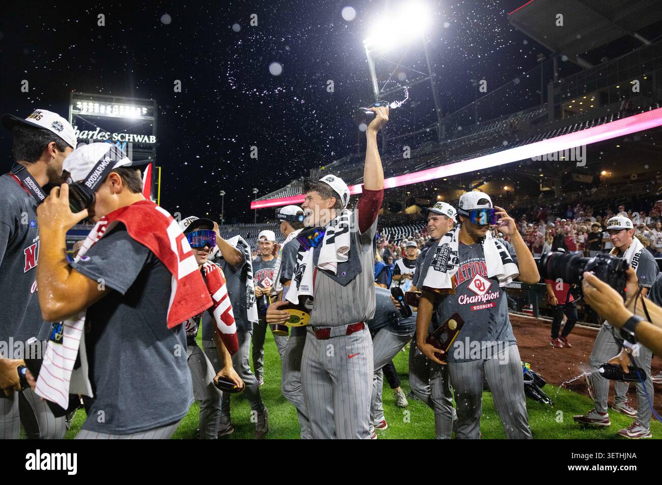 Oklahoma players, including Isaac Williams, center, spray water in ...