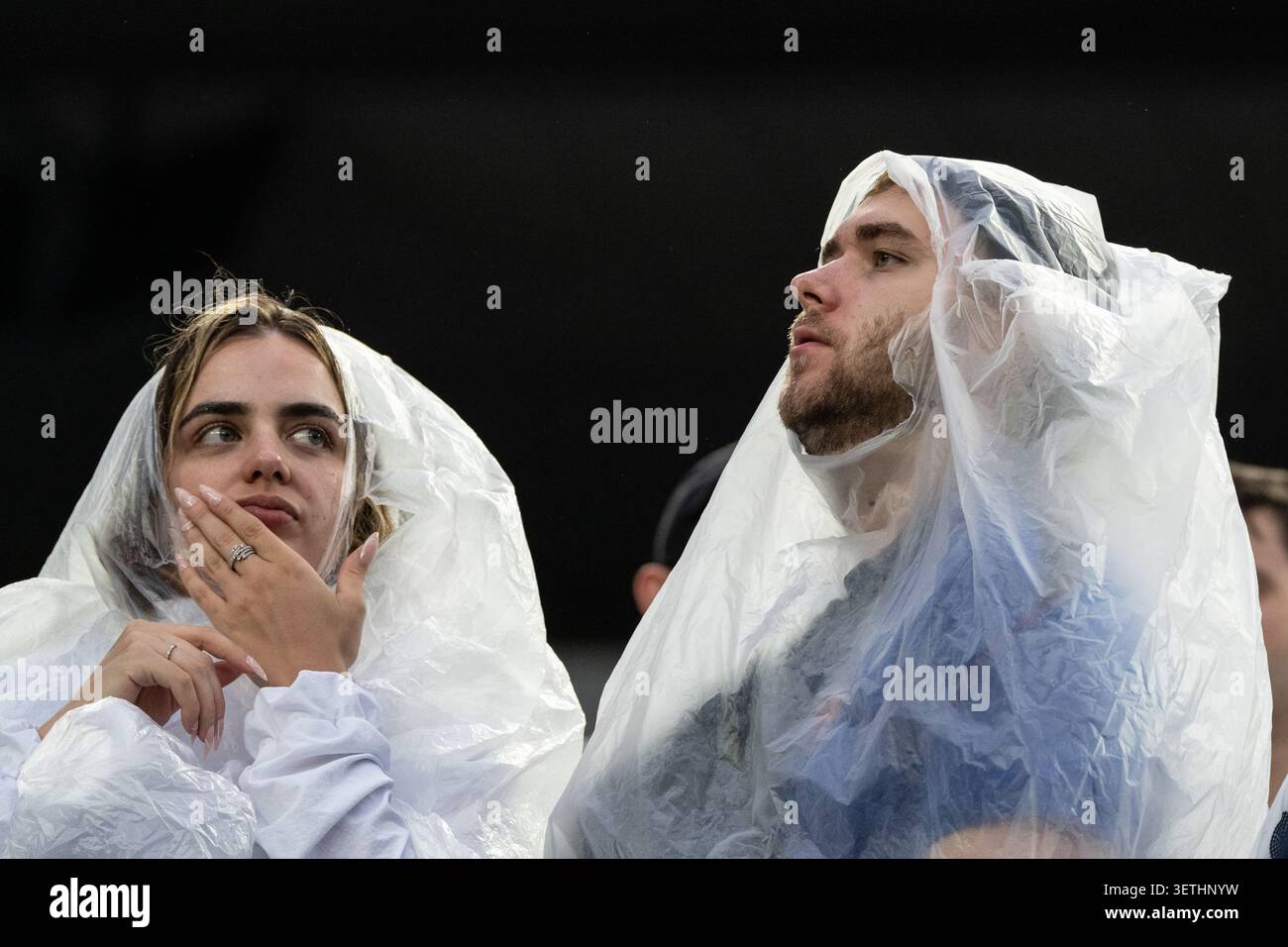Fans wearing rain ponchos attend group stage game between France and ...