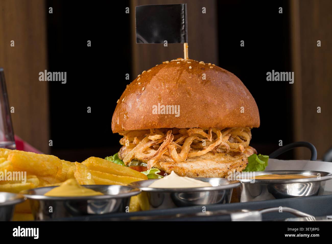 Crispy chicken burger with fried onions and french fries Stock Photo ...