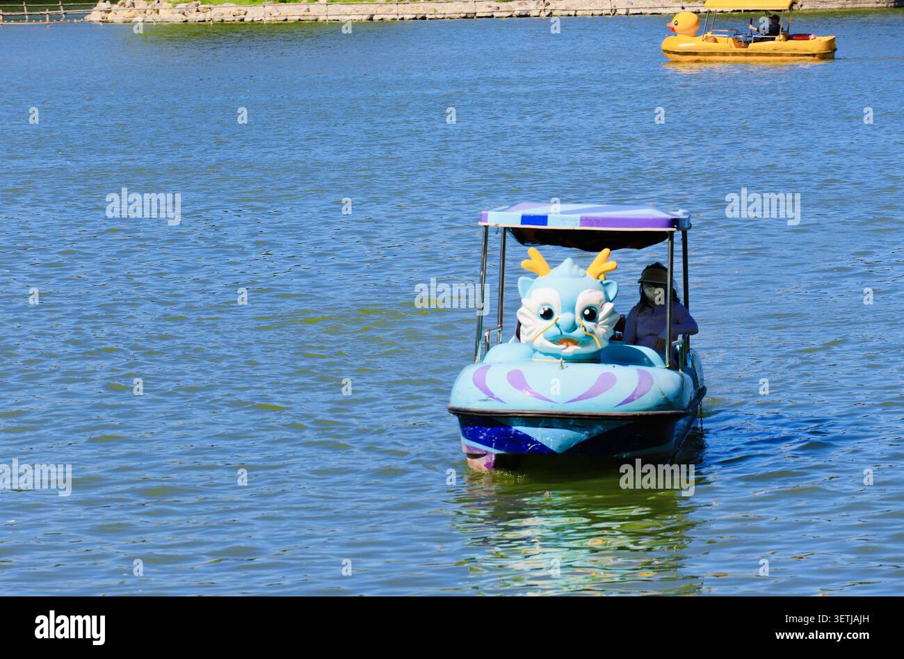 Visitors enjoy boating in Longtan Park with a view of China Zun in ...