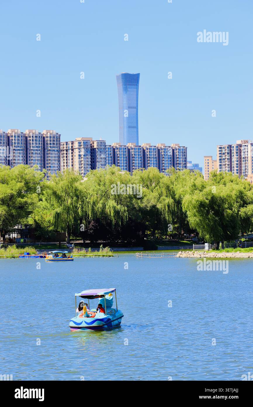 Visitors enjoy boating in Longtan Park with a view of China Zun in ...