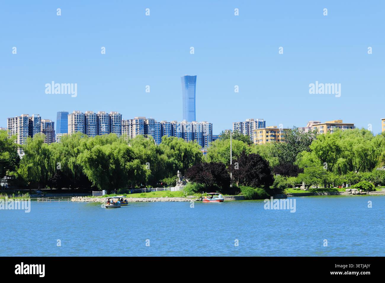 Visitors enjoy boating in Longtan Park with a view of China Zun in ...