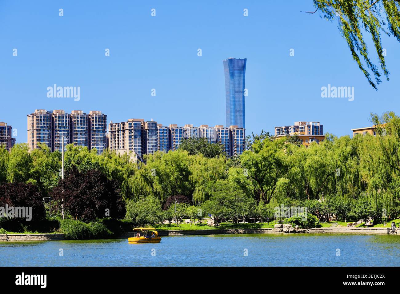 Visitors enjoy boating in Longtan Park with a view of China Zun in ...