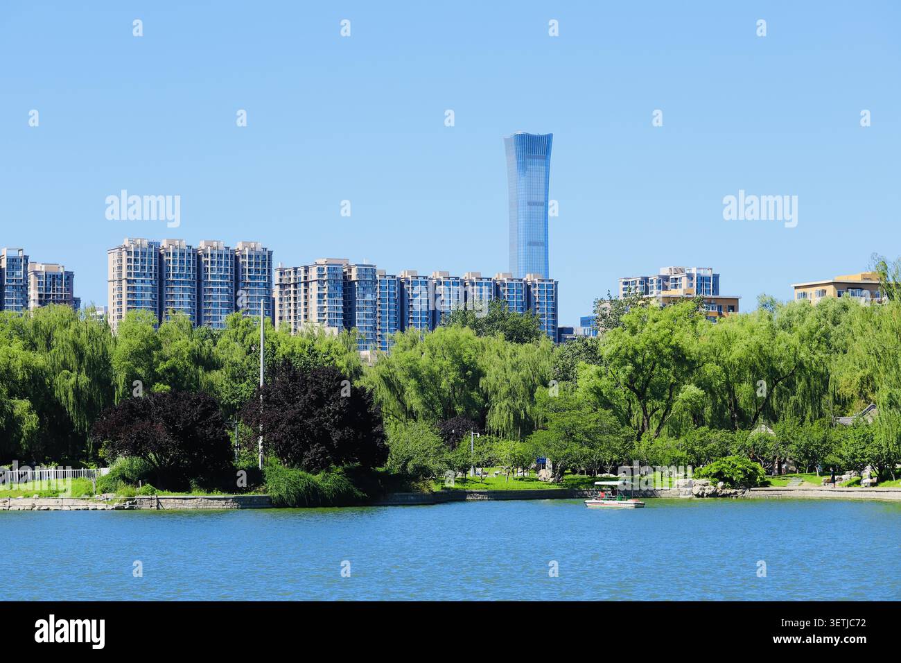 Visitors enjoy boating in Longtan Park with a view of China Zun in ...
