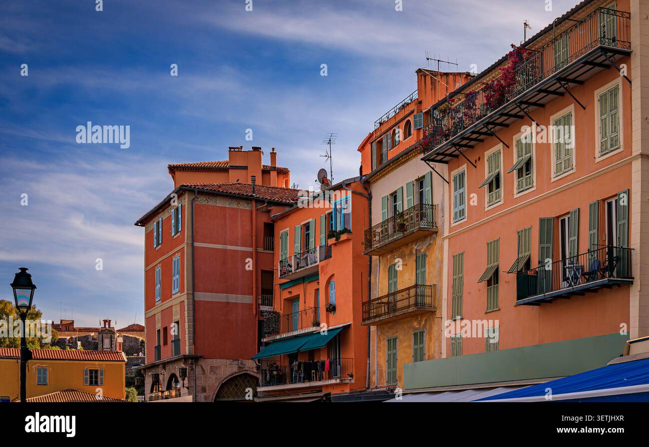 Traditional old terracotta houses on a street in Villefranche sur Mer ...