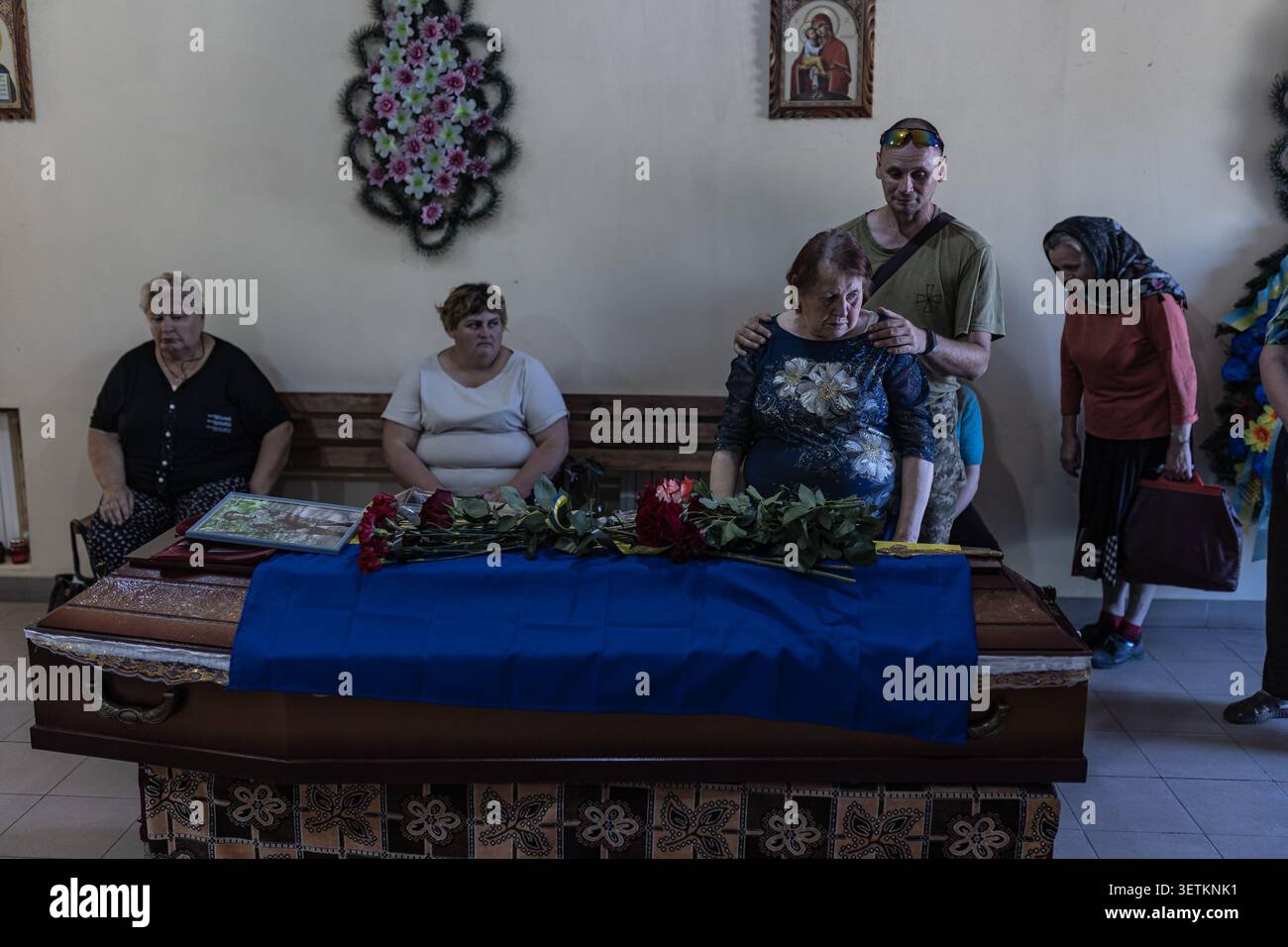 Relatives attend to the funeral of Roman Godina, a 39-year-old ...
