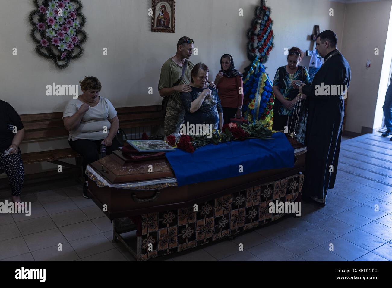Relatives attend to the funeral of Roman Godina, a 39-year-old ...