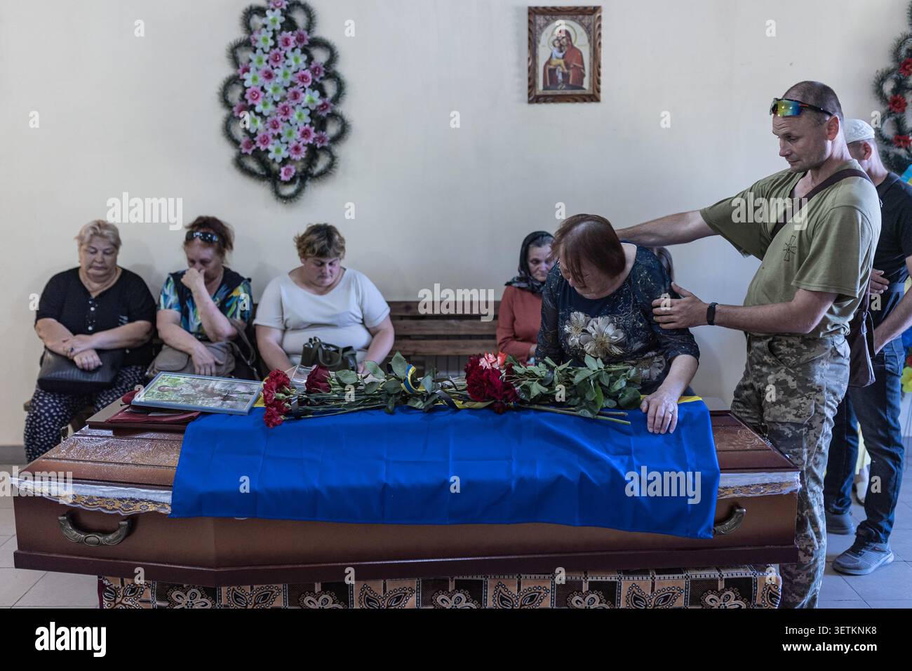 Relatives attend to the funeral of Roman Godina, a 39-year-old ...