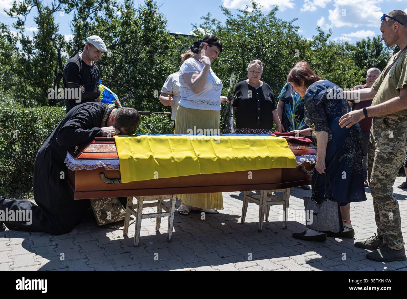 Relatives attend to the funeral of Roman Godina, a 39-year-old ...