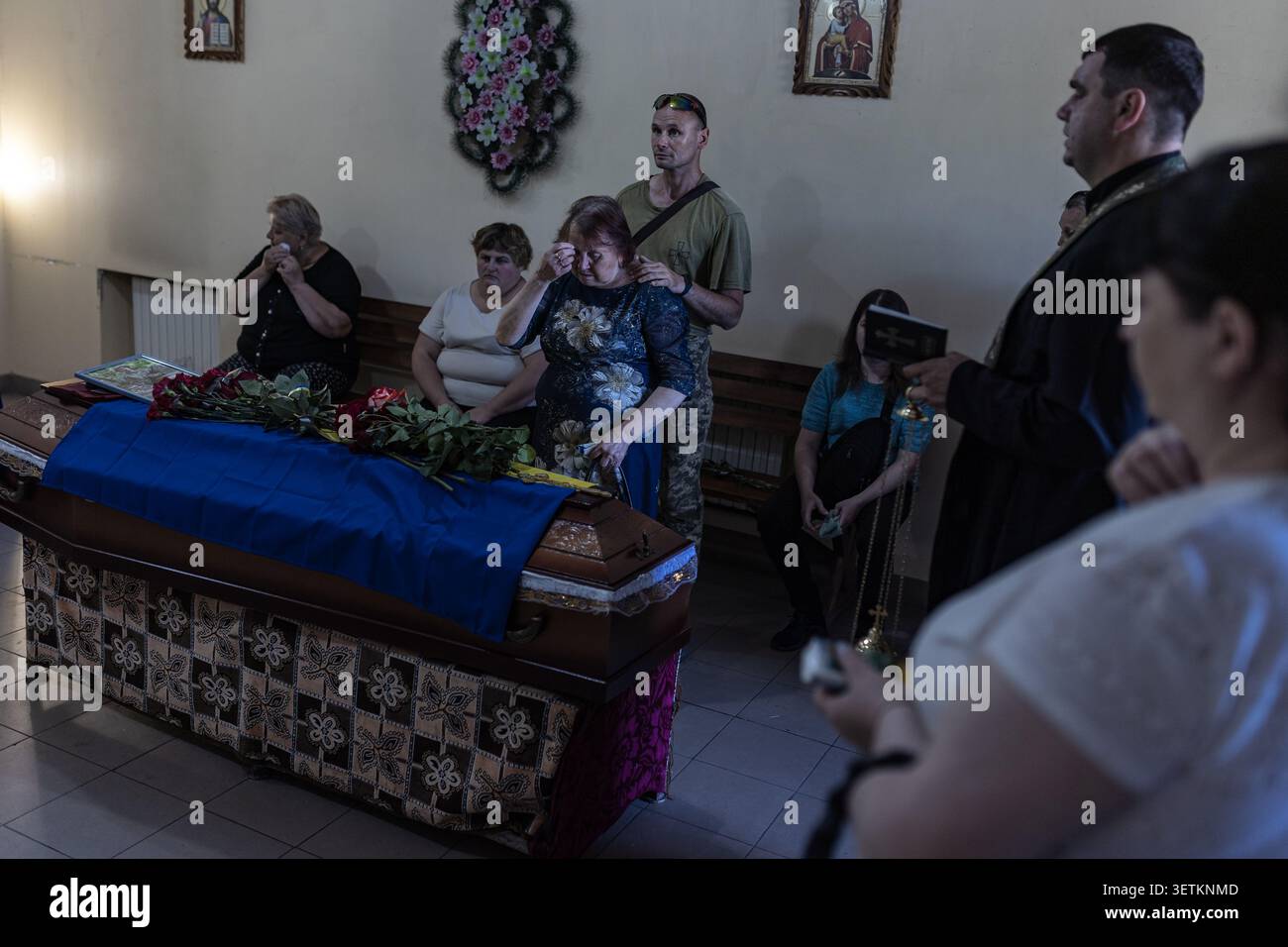 Relatives attend to the funeral of Roman Godina, a 39-year-old ...