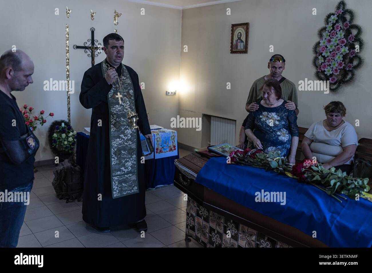 Relatives attend to the funeral of Roman Godina, a 39-year-old ...