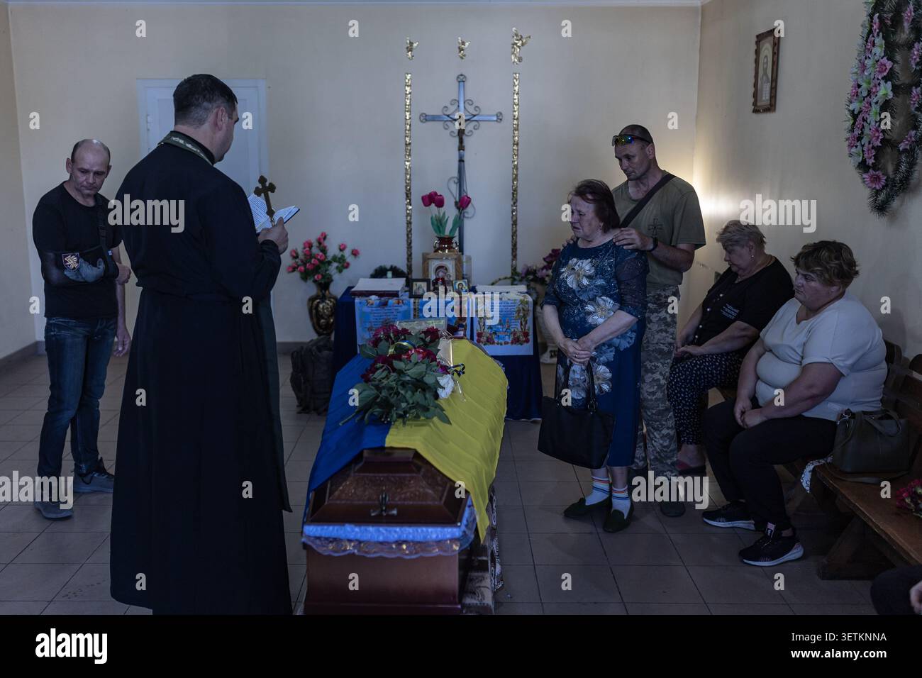 Relatives attend to the funeral of Roman Godina, a 39-year-old ...