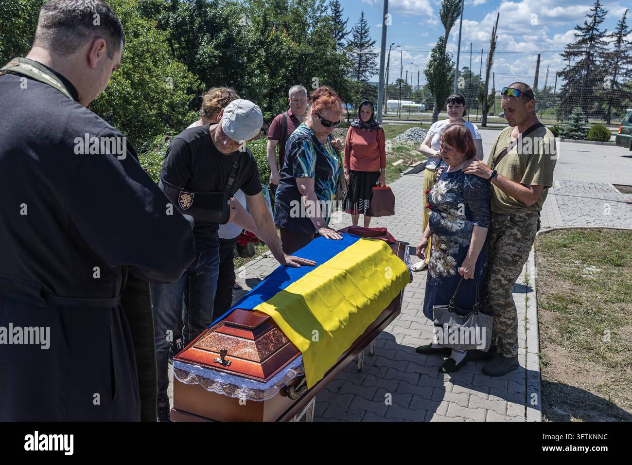 Relatives attend to the funeral of Roman Godina, a 39-year-old ...