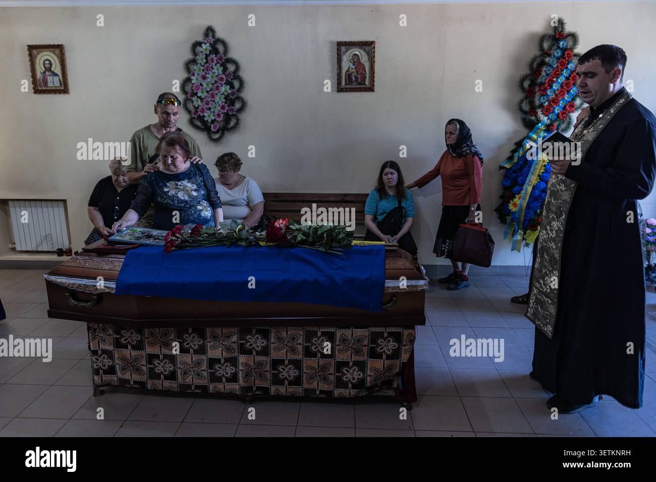 Relatives attend to the funeral of Roman Godina, a 39-year-old ...