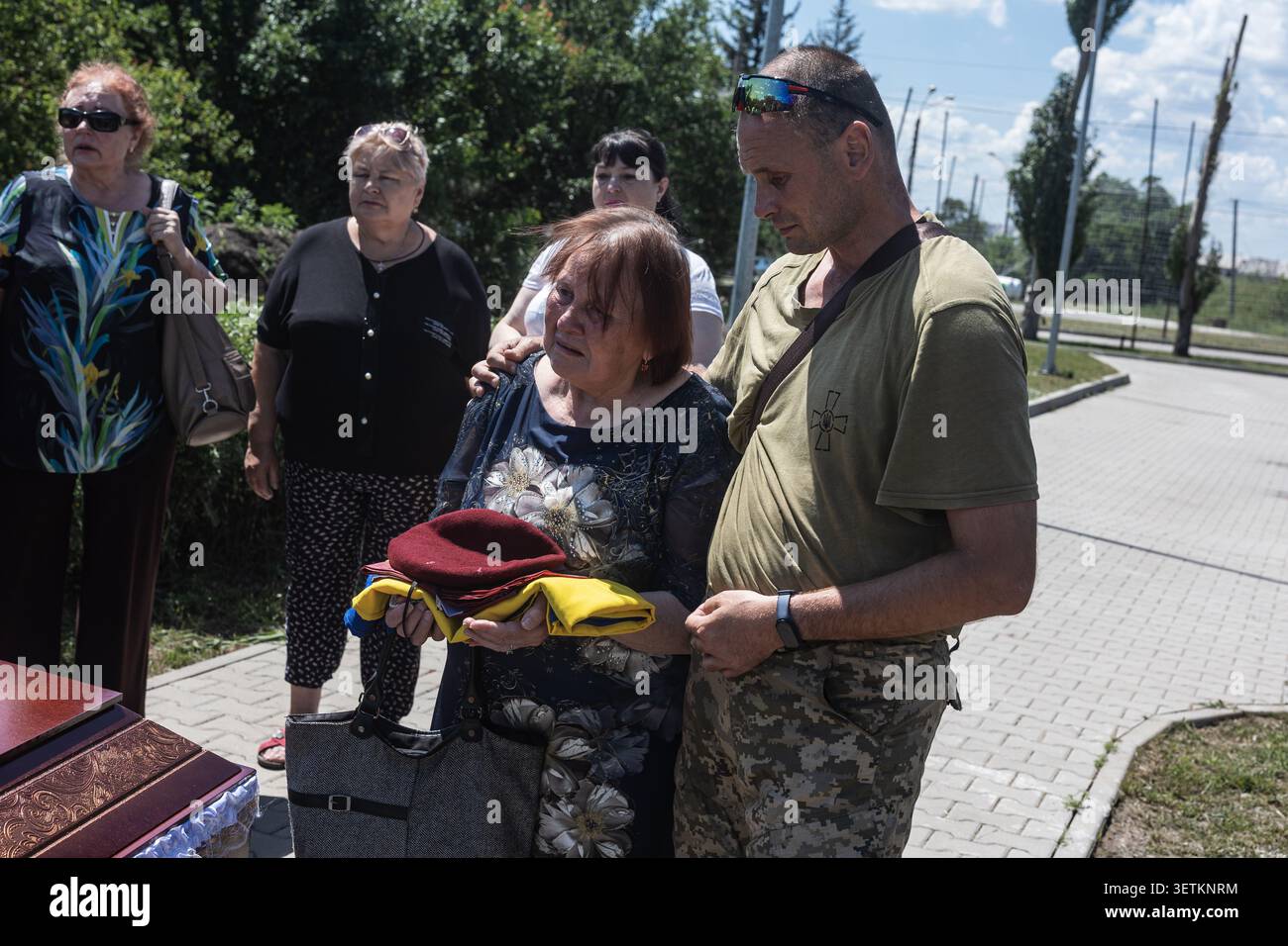 Relatives attend to the funeral of Roman Godina, a 39-year-old ...