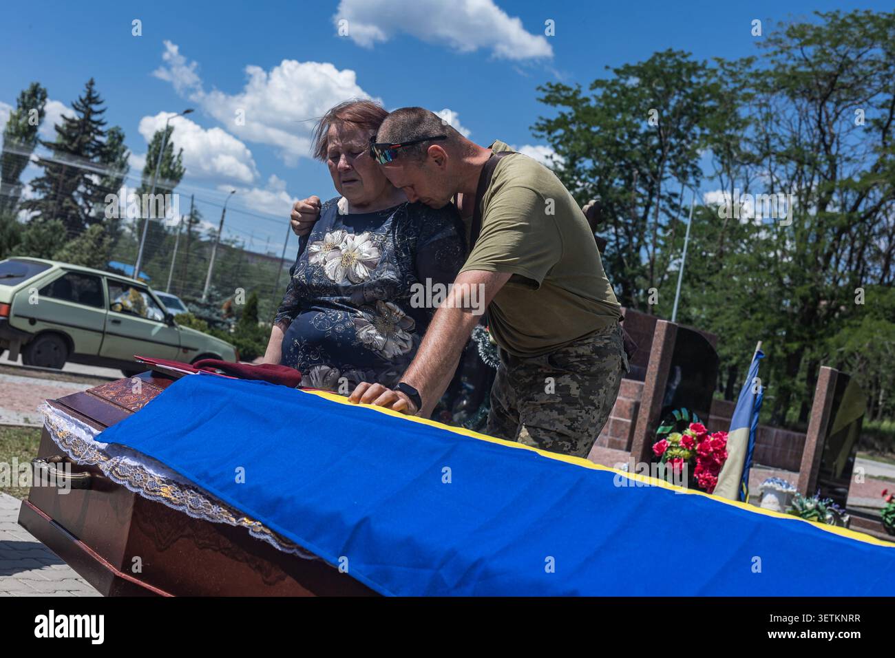 Relatives attend to the funeral of Roman Godina, a 39-year-old ...