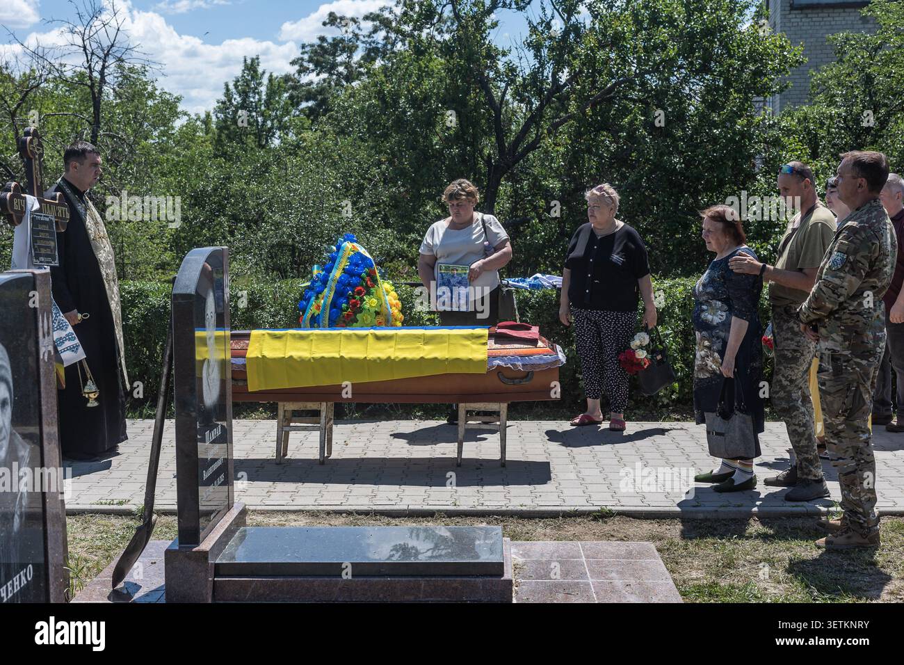Relatives attend to the funeral of Roman Godina, a 39-year-old ...