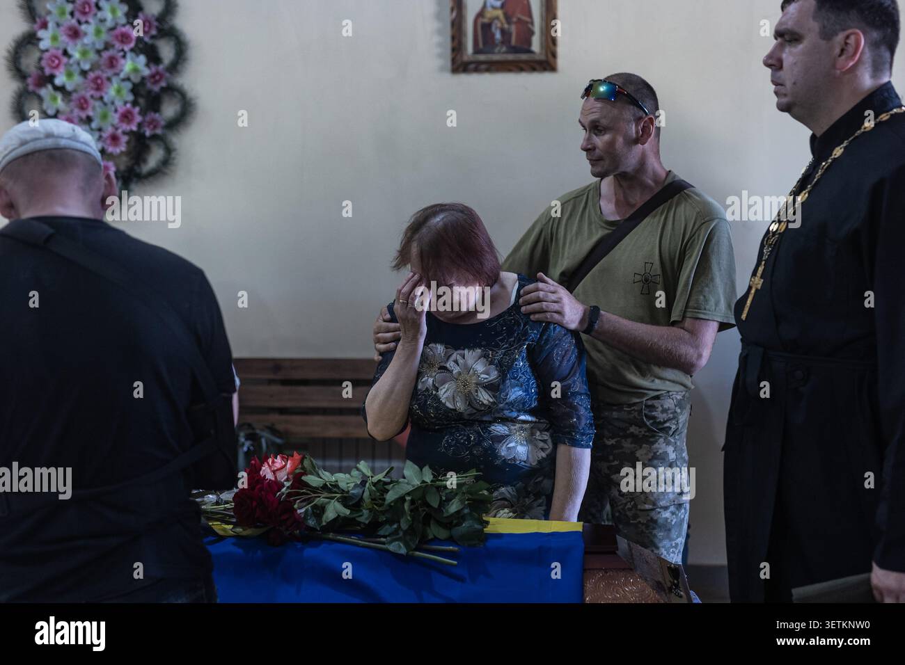 Relatives attend to the funeral of Roman Godina, a 39-year-old ...