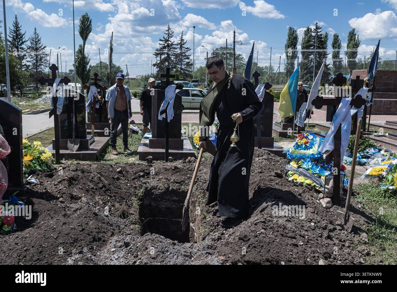 Relatives attend to the funeral of Roman Godina, a 39-year-old ...