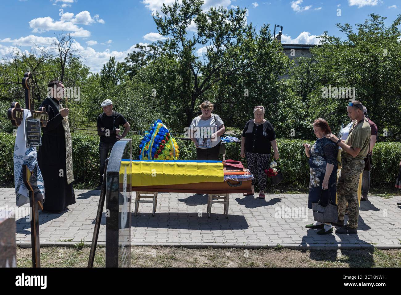 Relatives attend to the funeral of Roman Godina, a 39-year-old ...