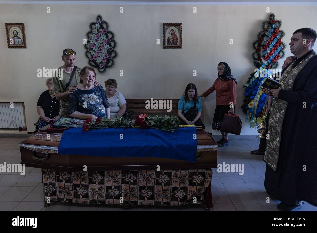 Relatives attend to the funeral of Roman Godina, a 39-year-old ...