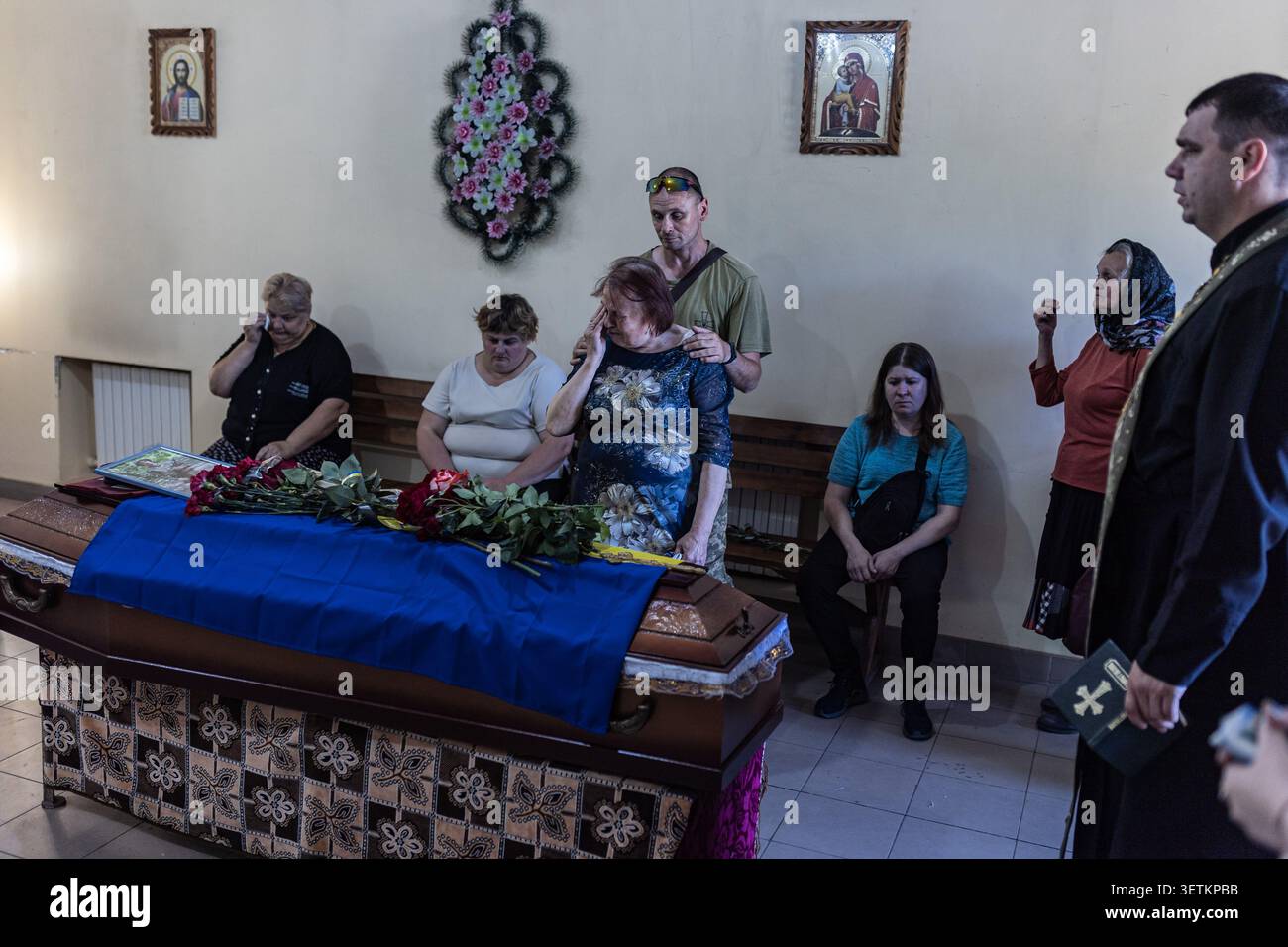 Relatives attend to the funeral of Roman Godina, a 39-year-old ...