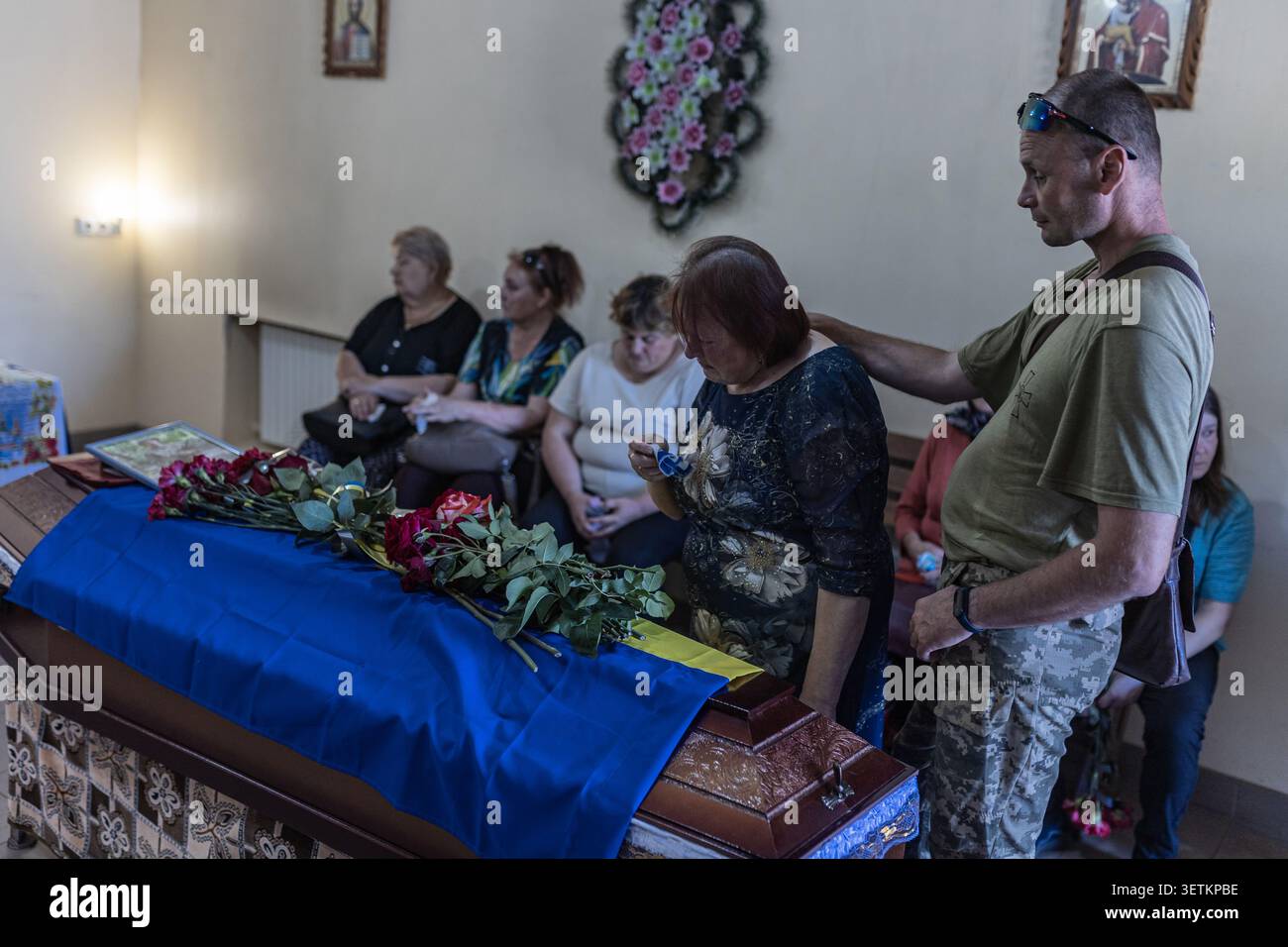 Relatives attend to the funeral of Roman Godina, a 39-year-old ...