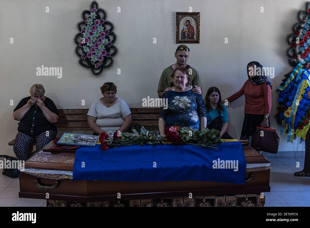 Relatives attend to the funeral of Roman Godina, a 39-year-old ...