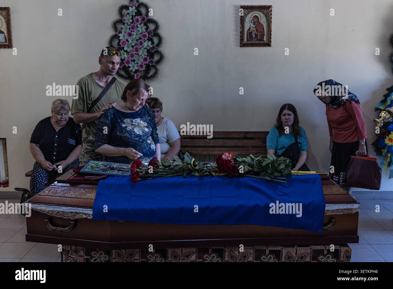 Relatives attend to the funeral of Roman Godina, a 39-year-old ...