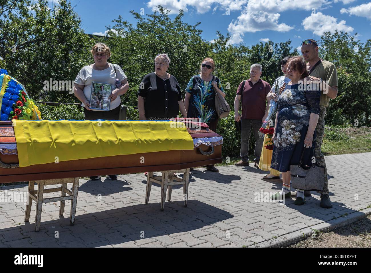 Relatives attend to the funeral of Roman Godina, a 39-year-old ...