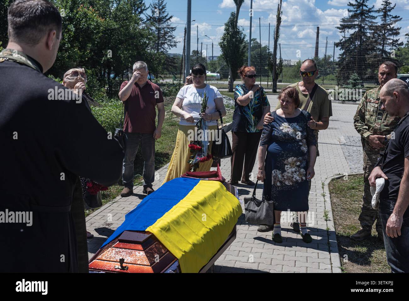 Relatives attend to the funeral of Roman Godina, a 39-year-old ...