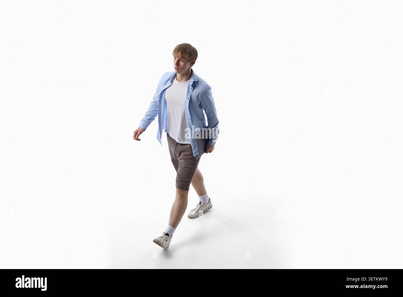 Teenage boy walking in white casual clothes isolated on white ...