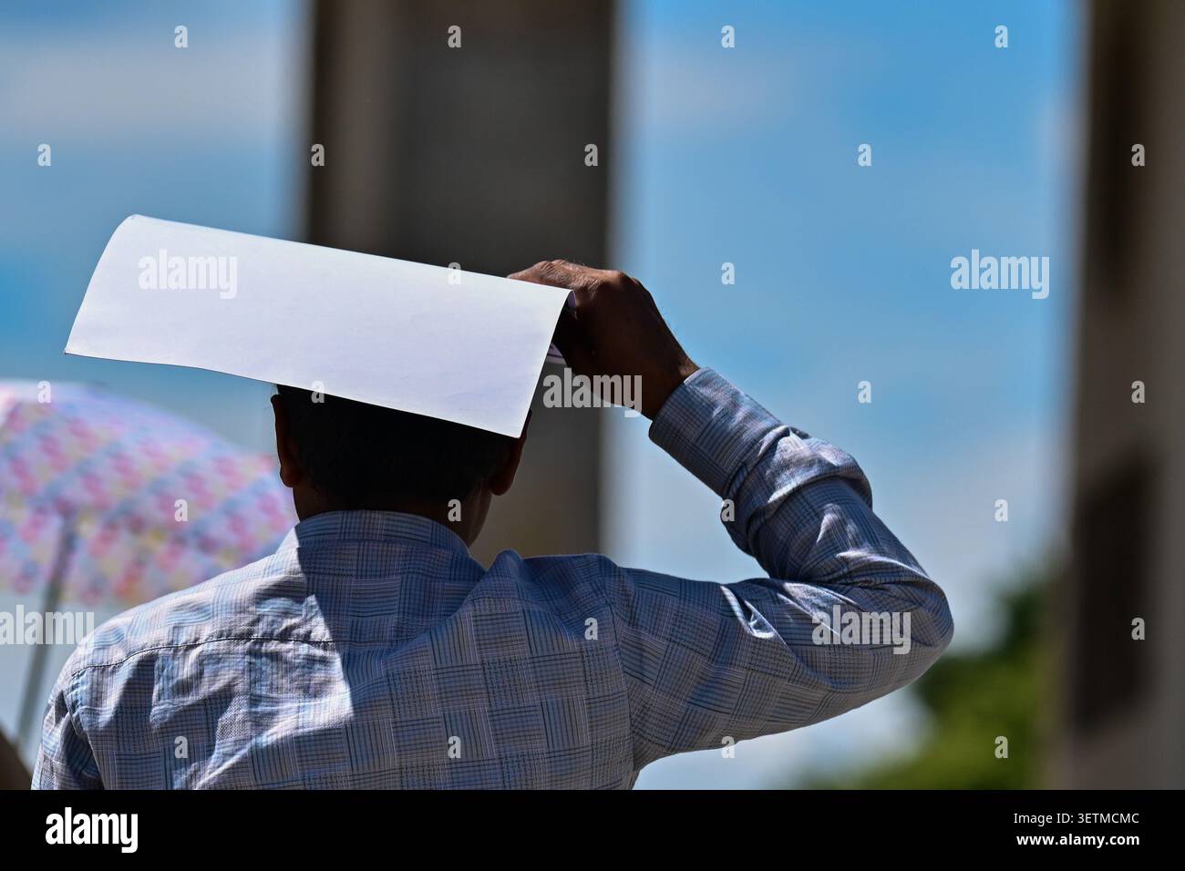 23 June 2026, Berlin: A man stands in front of the Brandenburg Gate ...