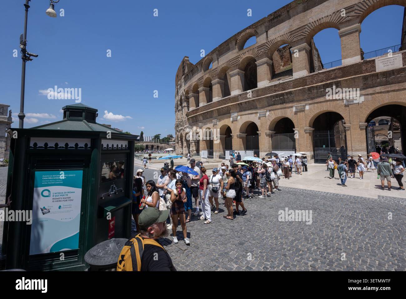 IPA85973550 - Tourists waiting in line at a water dispenser in front of ...