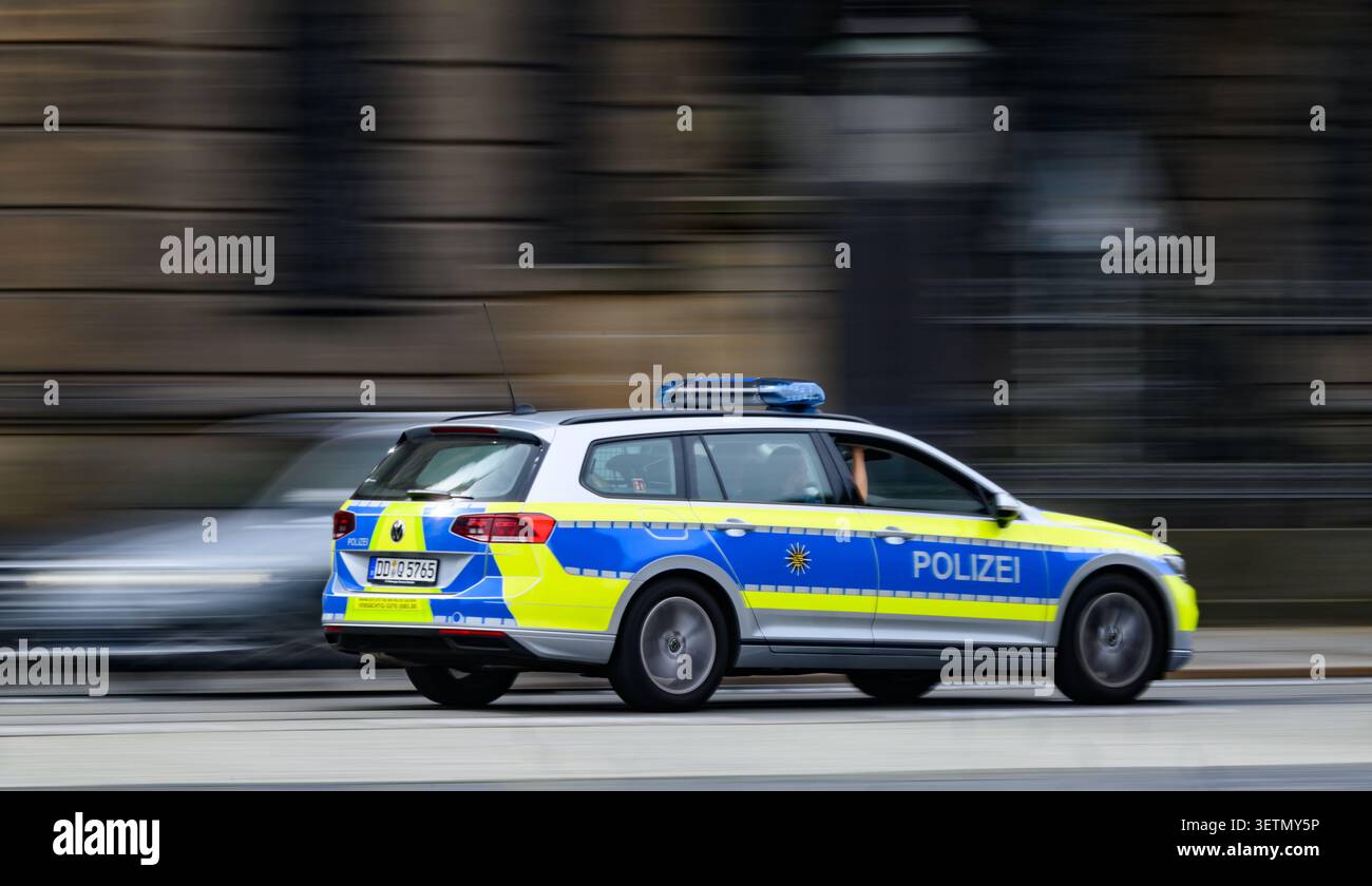23 June 2026, Saxony, Dresden: A police car drives across Theaterplatz ...