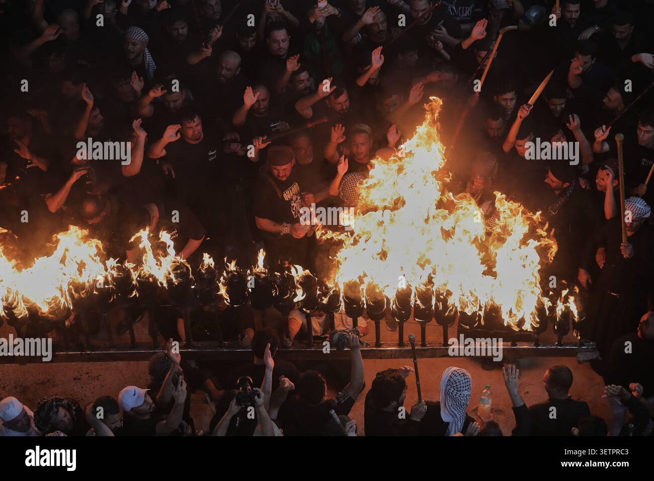 Shiite faithful pilgrims do their ritual during a Muharram procession ...