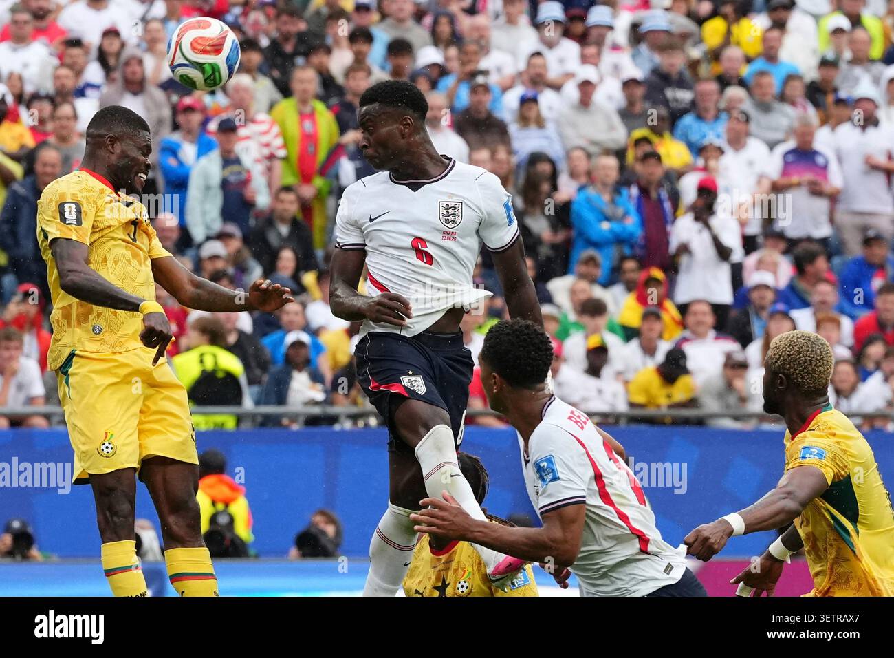 Ghana's Caleb Yirenkyi (3), left, heads for the ball with England's ...