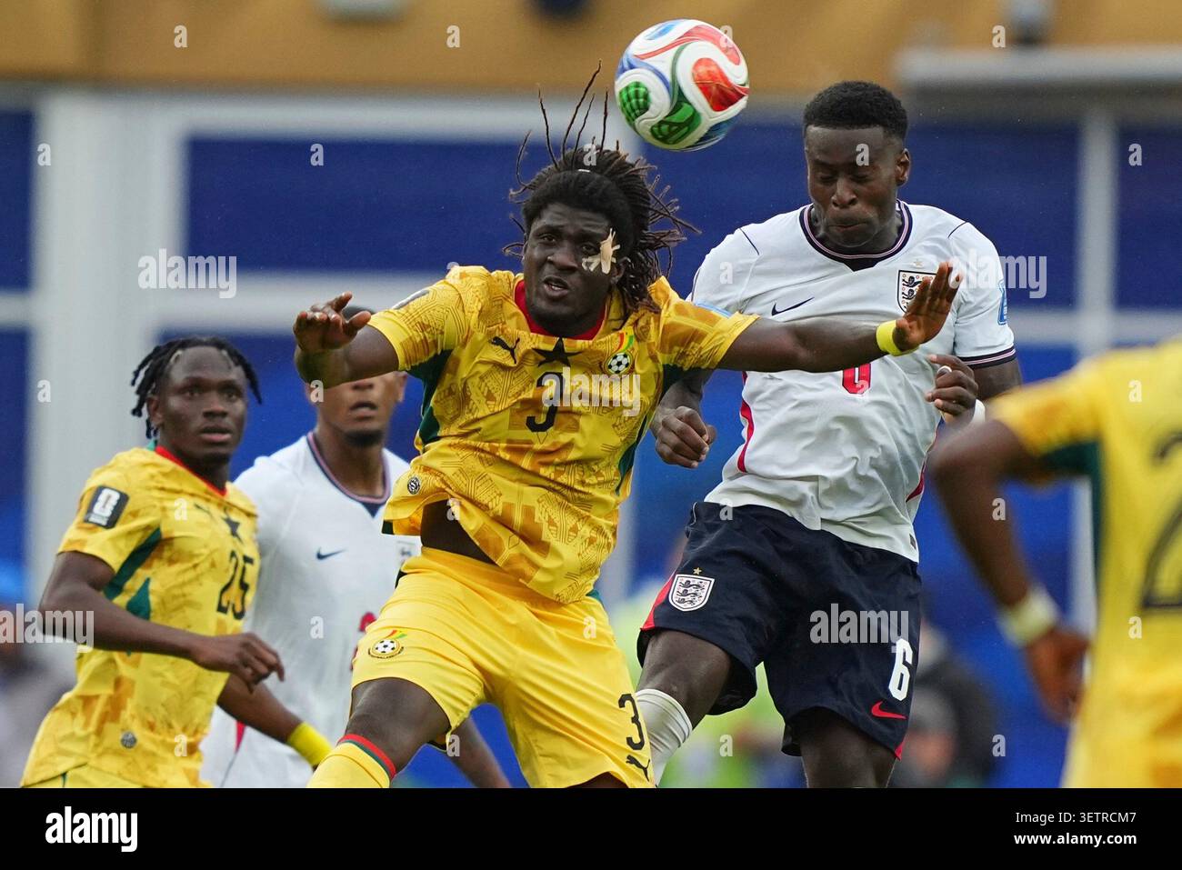 Ghana's Caleb Yirenkyi (3), left, heads for the ball with England's ...