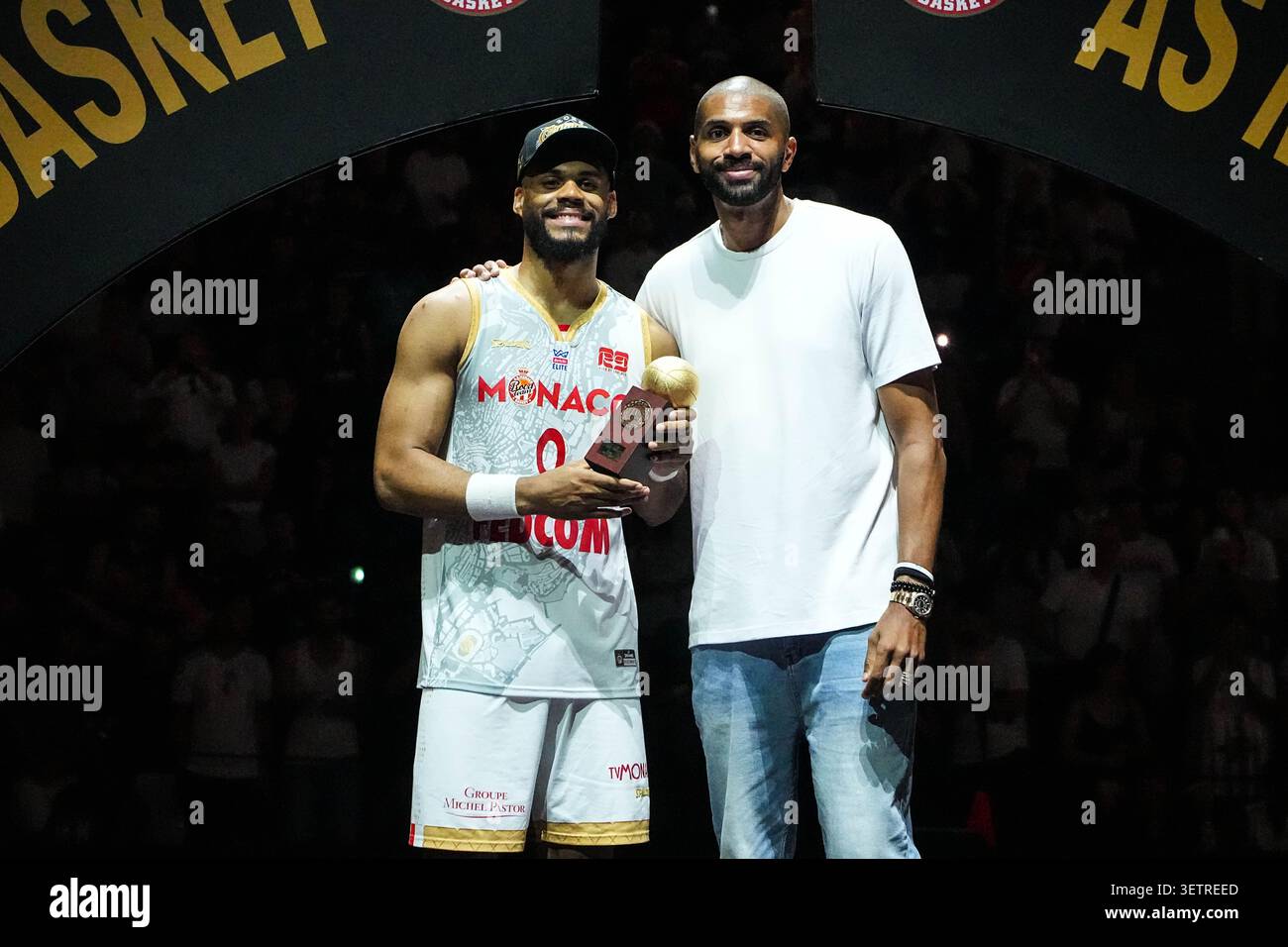 Elie OKOBO of Monaco receives finals map trophy from Nicholas BATUM ...